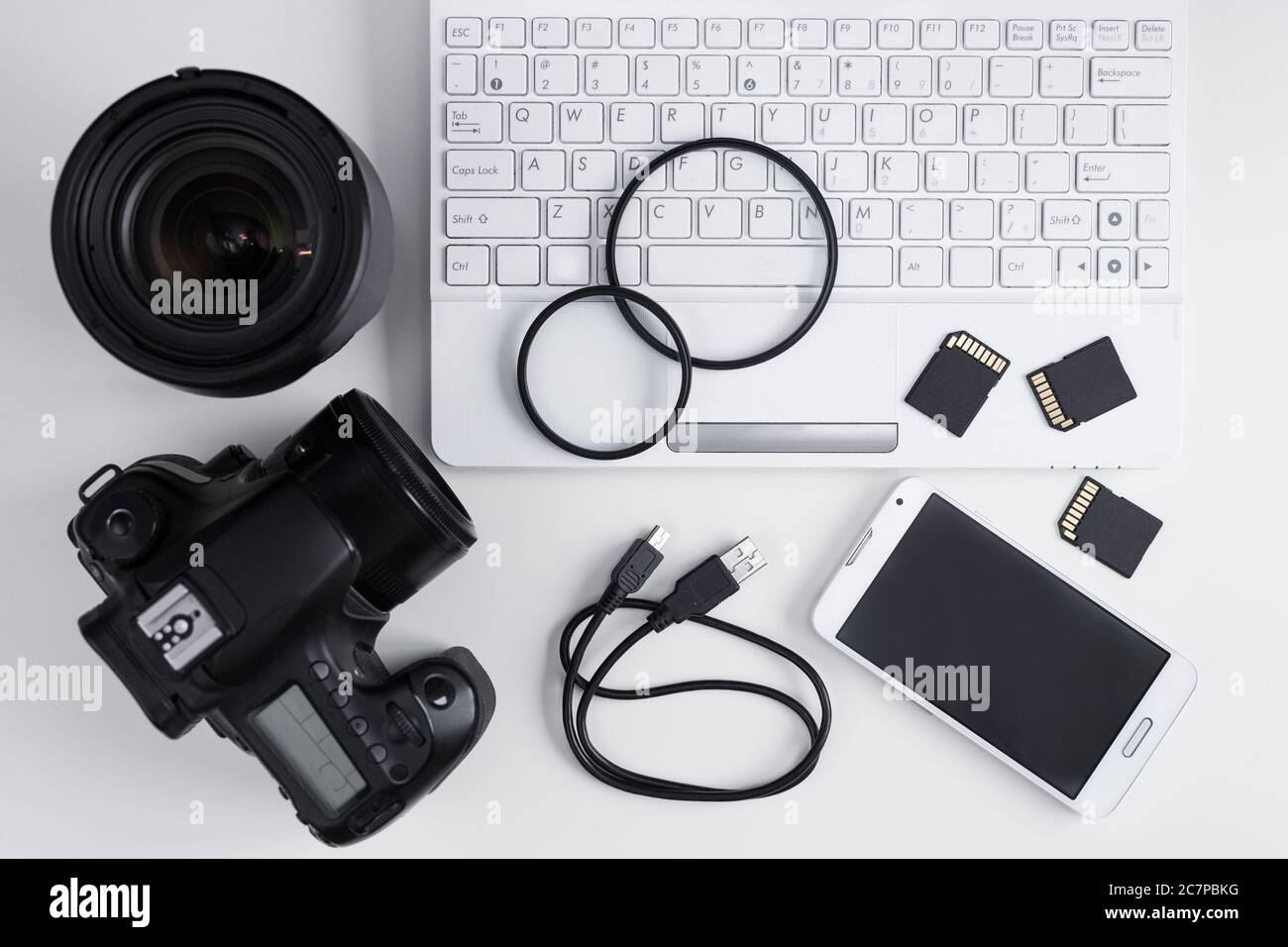 top view of camera, lenses, photo equipment and laptop over white table ...