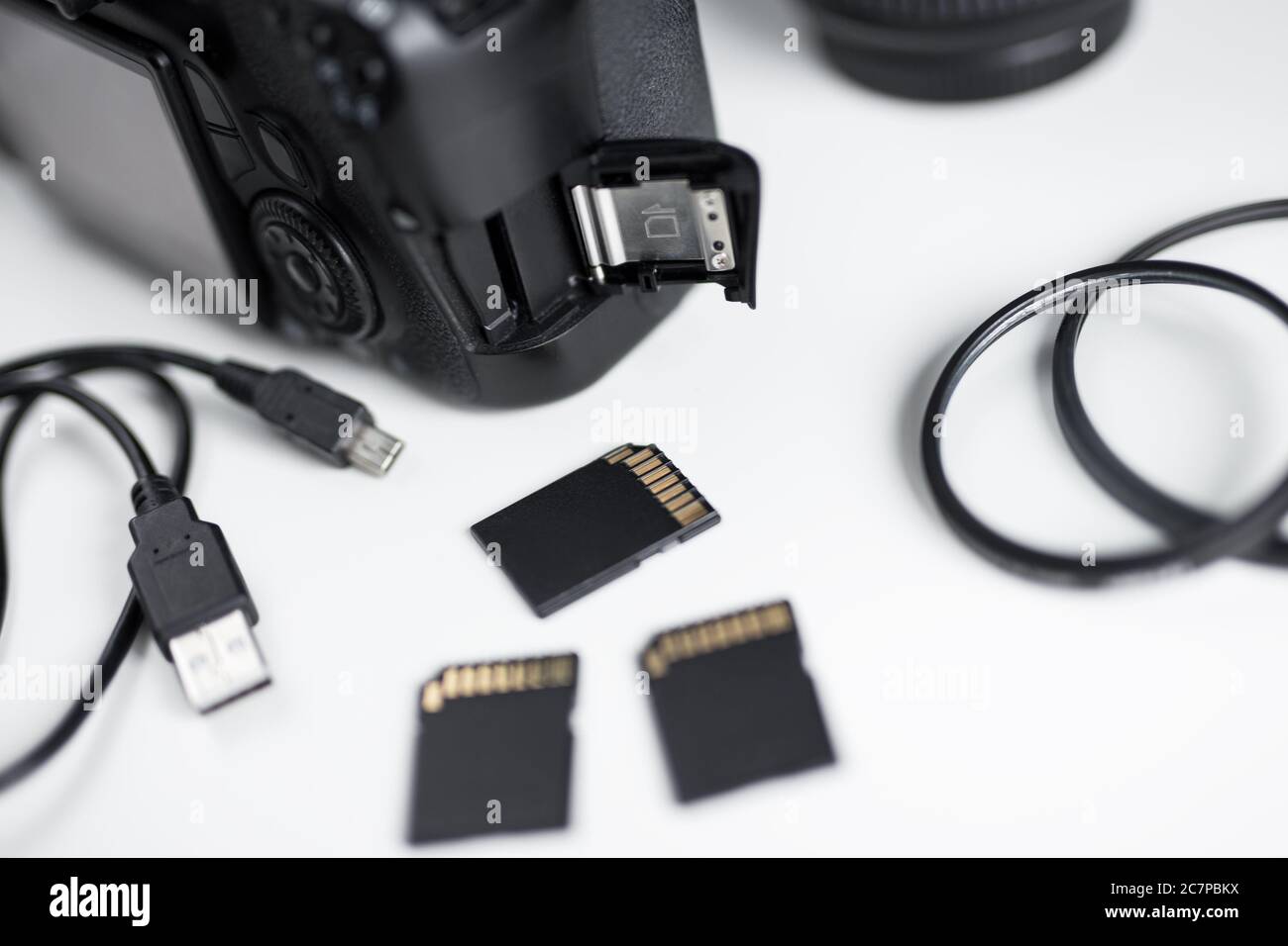 close up of modern dslr camera and sd memory card on the table Stock ...
