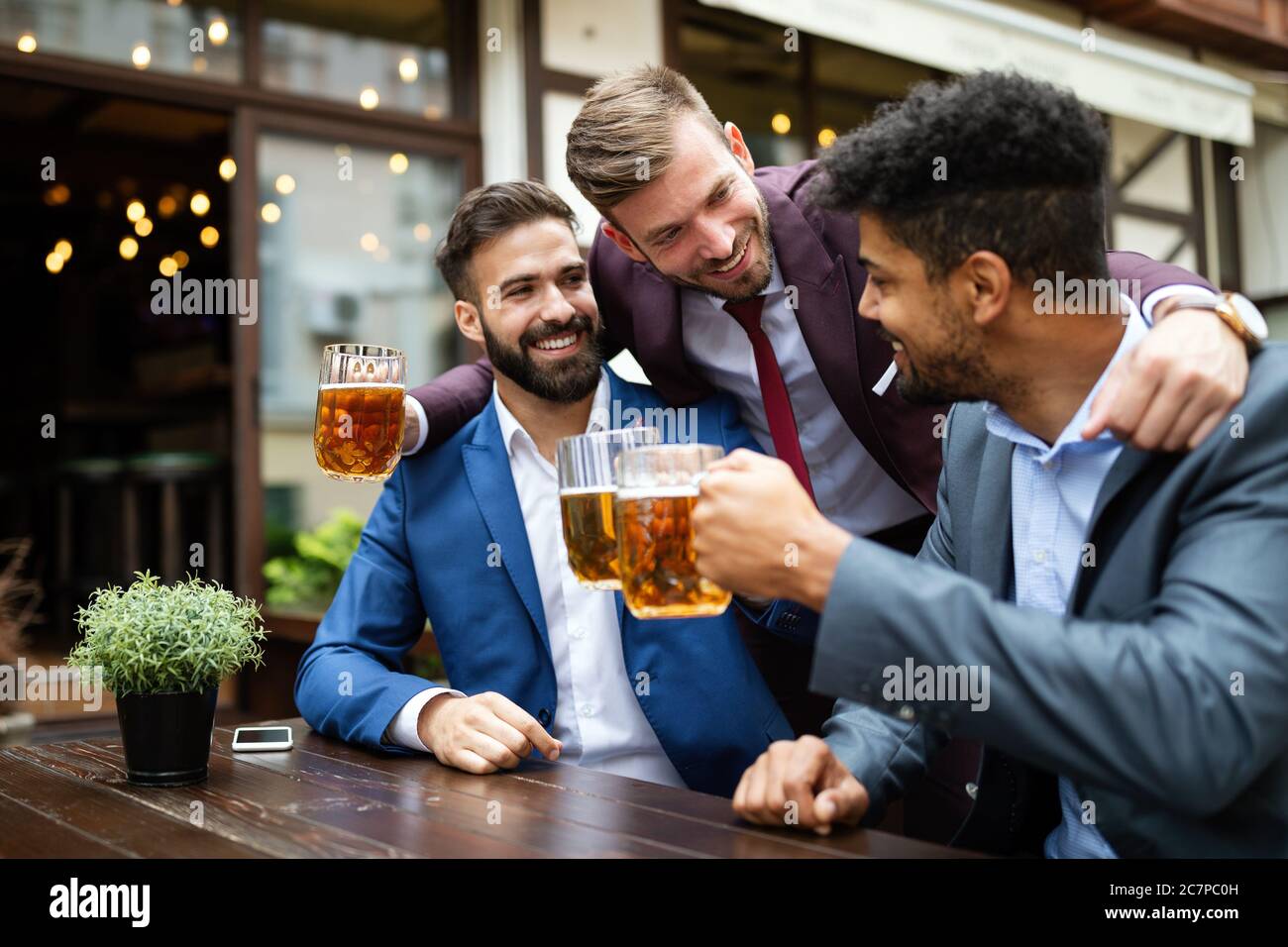 Team of colleagues socializing at the bar and drinking beers Stock ...