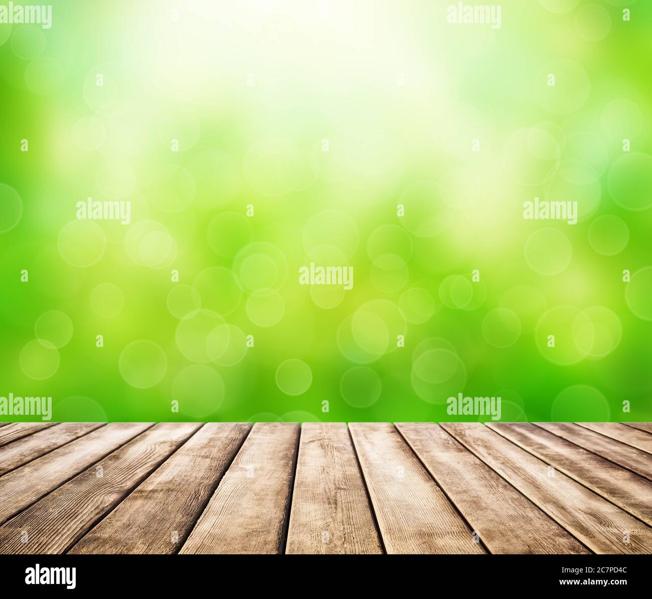 Wooden table on bokeh light green abstract background Stock Photo - Alamy