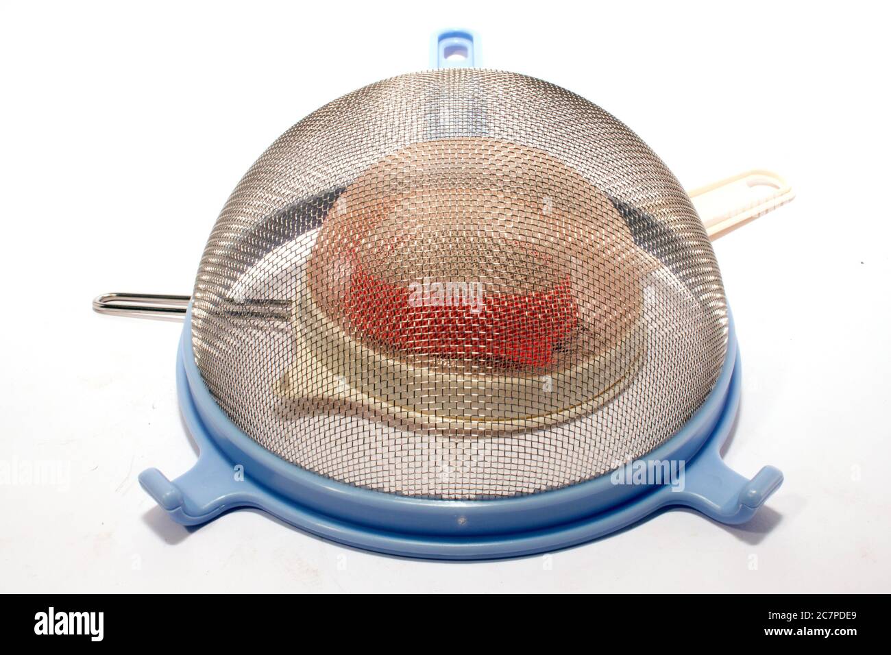 Closeup shot of different sizes of strainer isolated on a white ...