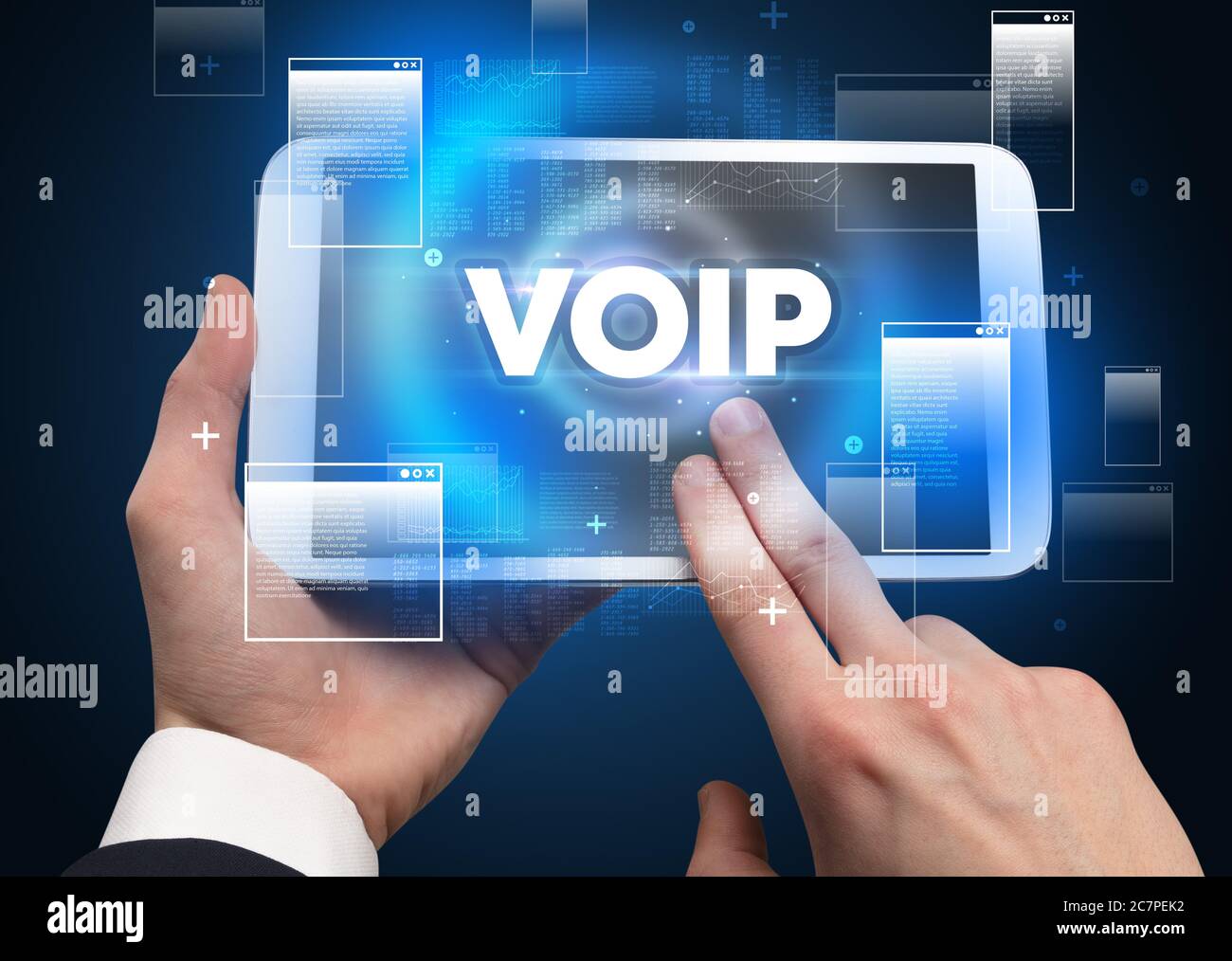 Close-up of a hand holding tablet with VOIP abbreviation, modern ...