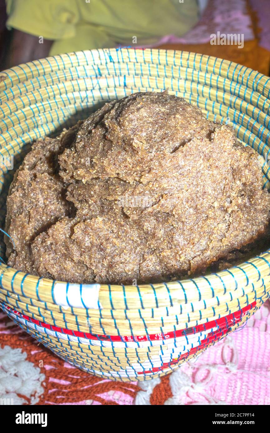 Finger millet (Eleusine coracana) being crushed into flour for porridge ...