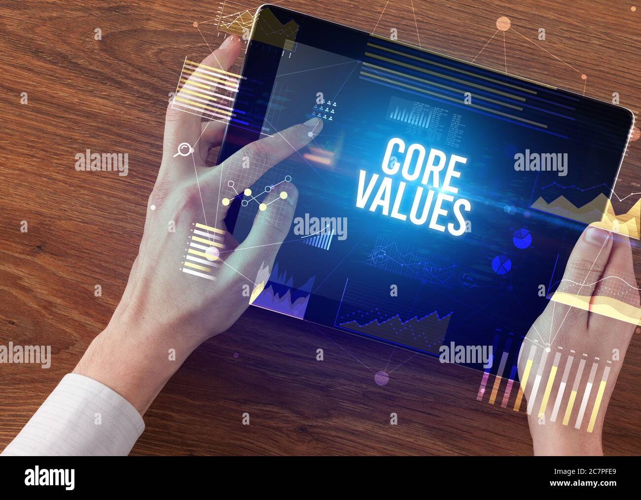 Close-up of hands holding tablet with CORE VALUES inscription, modern ...