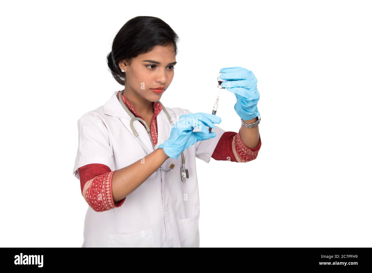 A female doctor with a stethoscope is holding an Injection or Syringe ...