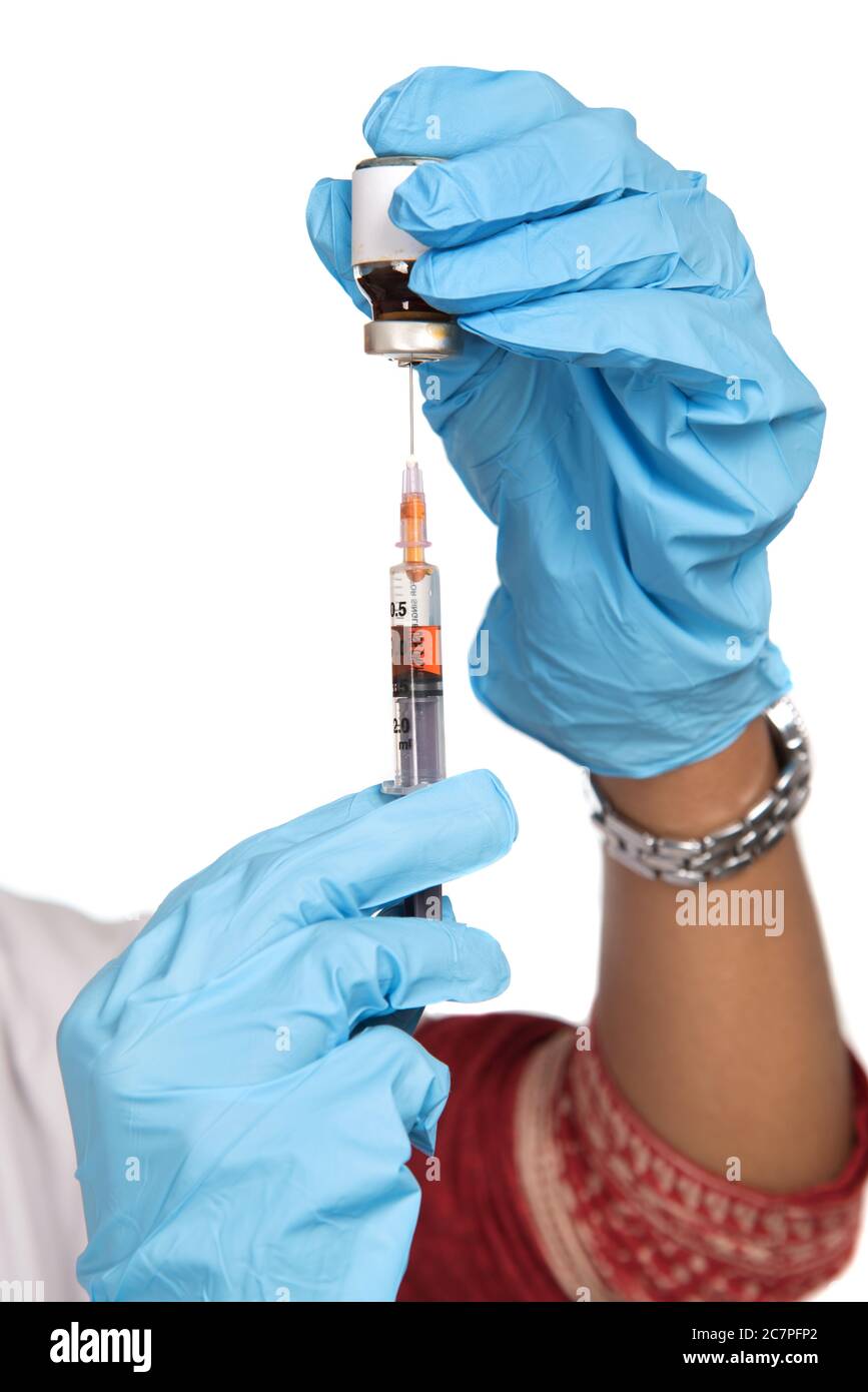 A female doctor with a stethoscope is holding an Injection or Syringe ...