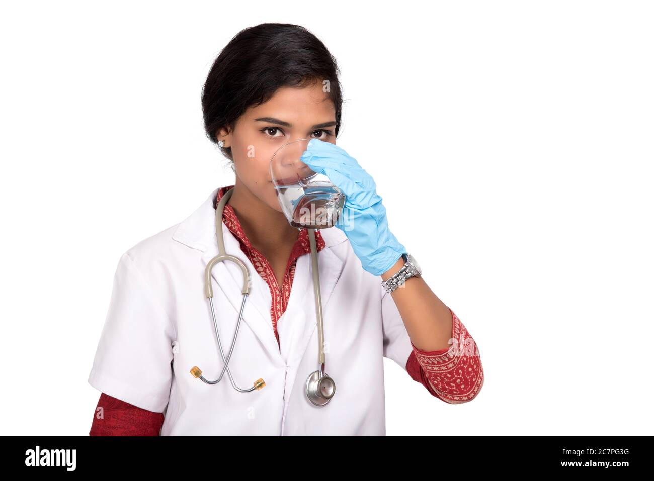 Healthy eating or lifestyle concept: young female doctor drink a glass ...