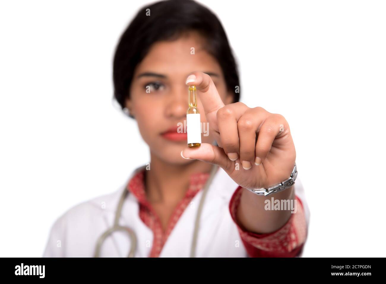 Female Doctor showing the tube of medicine on white background Stock ...