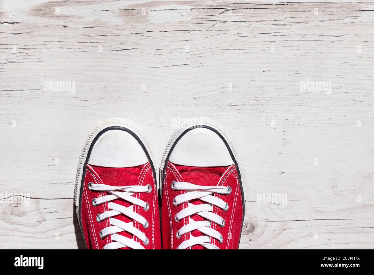 Old red shoes on wooden background Stock Photo - Alamy