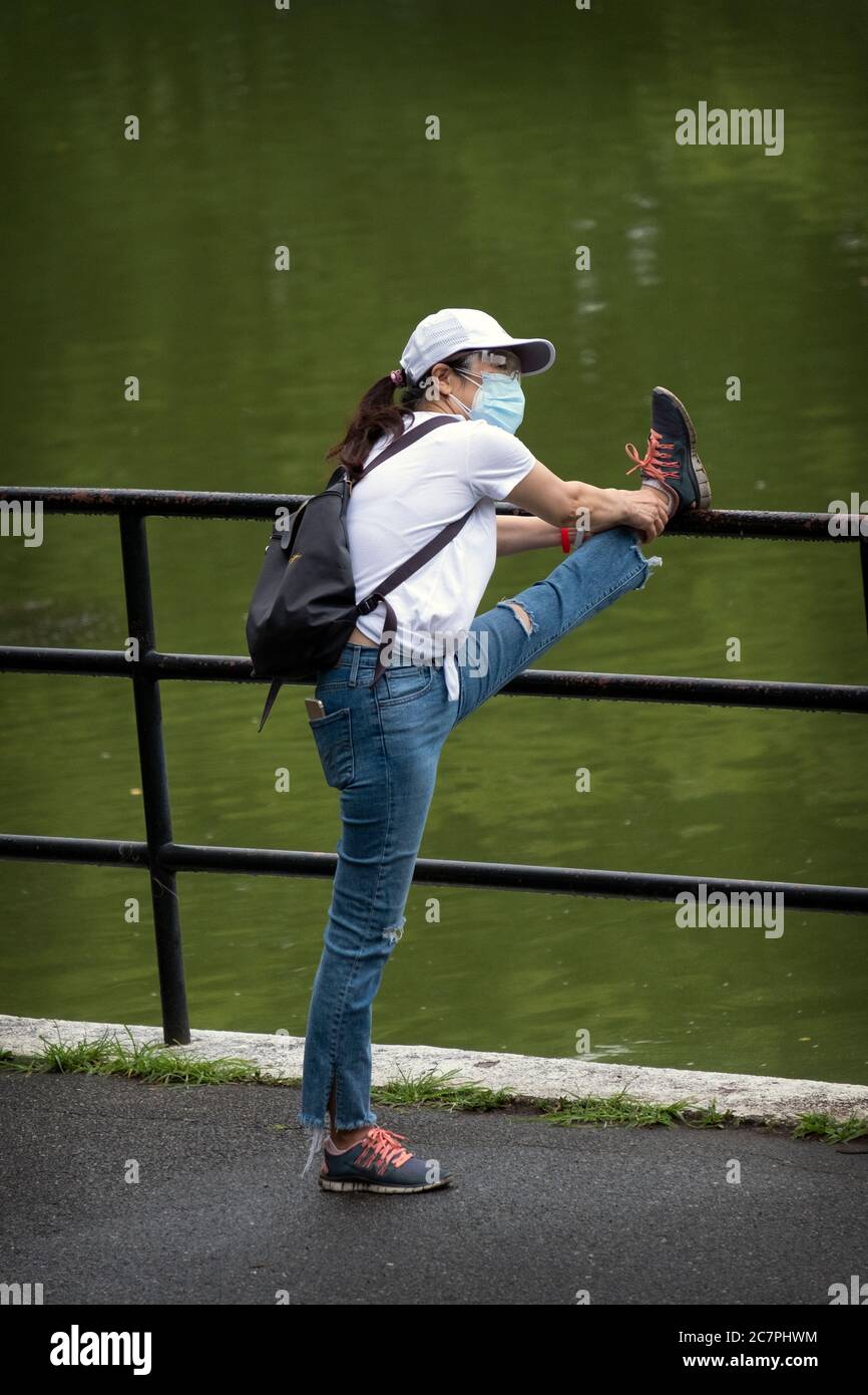 Woman warms up in park hi-res stock photography and images - Alamy