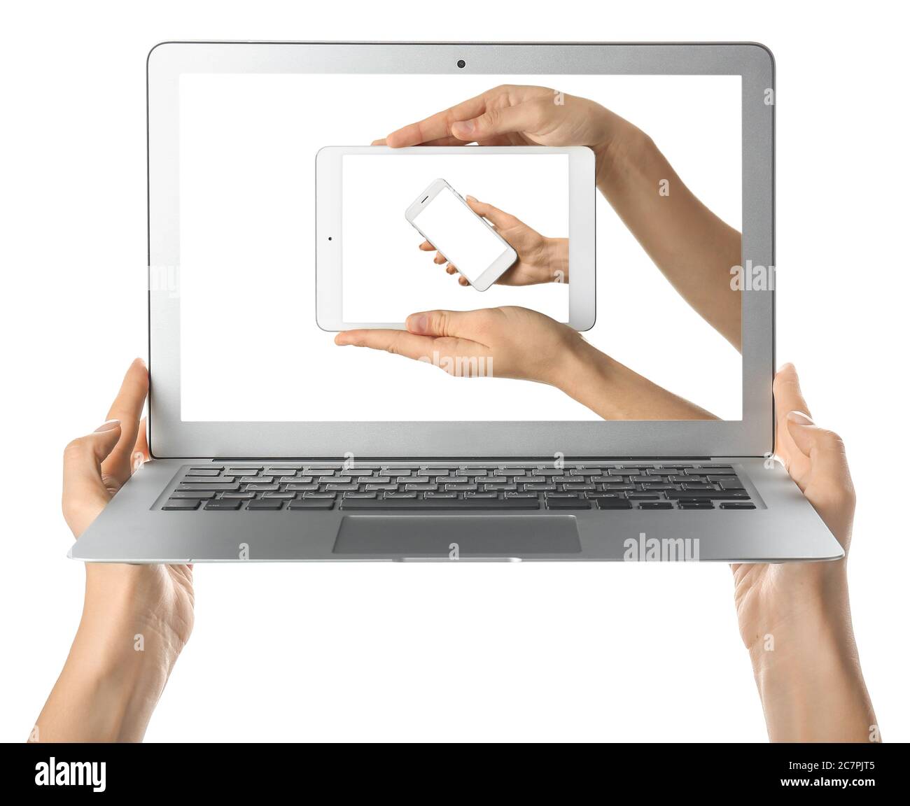 Hands holding laptop with gadgets on screen against white background ...