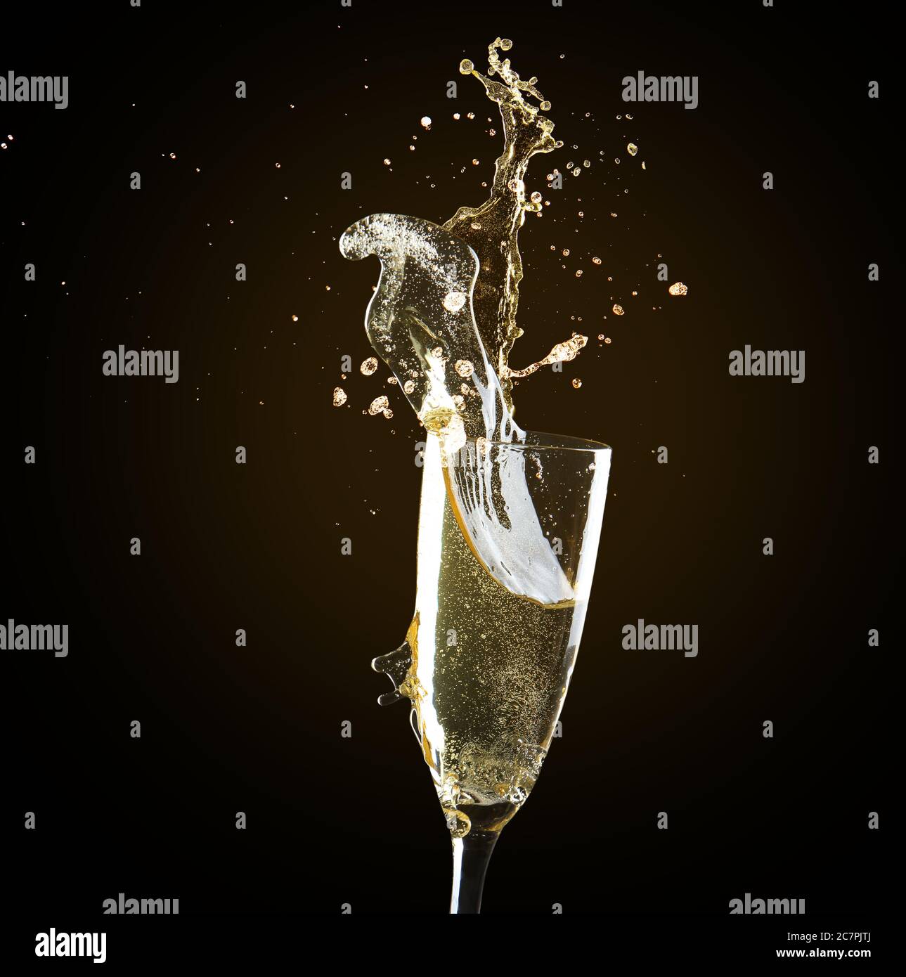 Glass of champagne with splash on dark background Stock Photo - Alamy