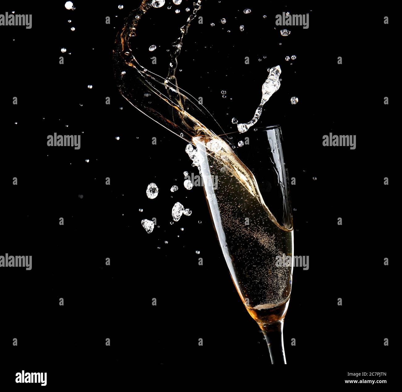 Glass of champagne with splash on dark background Stock Photo - Alamy