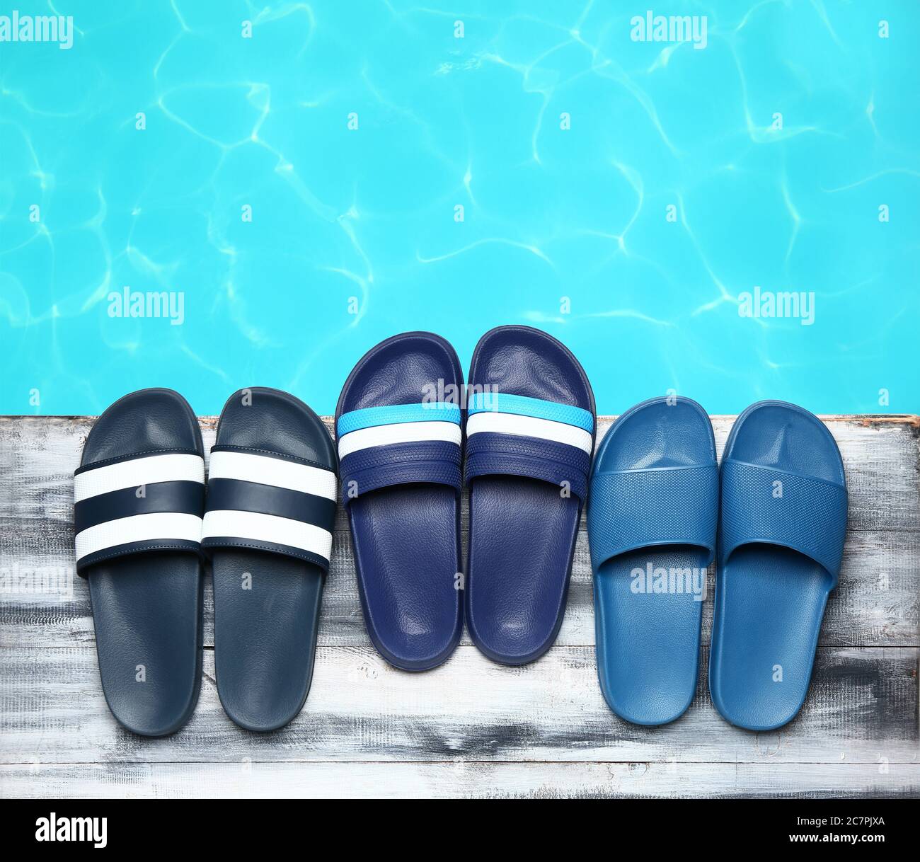 Flip-flops on the edge of swimming pool Stock Photo - Alamy