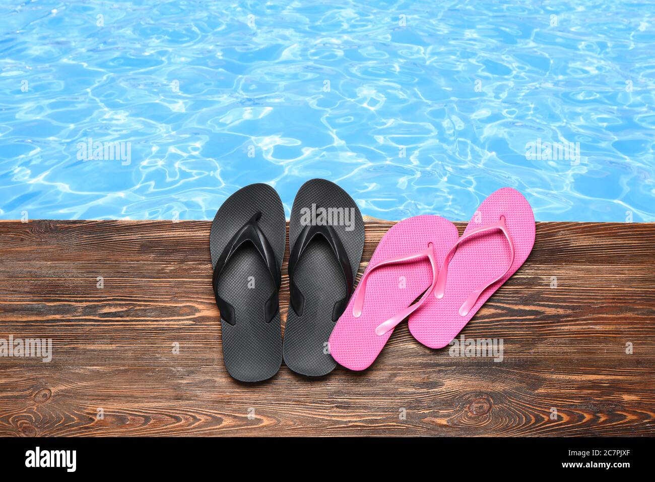 Flip-flops on the edge of swimming pool Stock Photo - Alamy