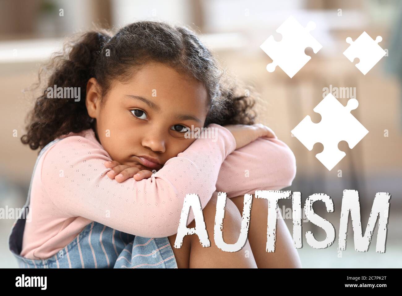 Little African-American girl with autistic disorder sitting at home ...