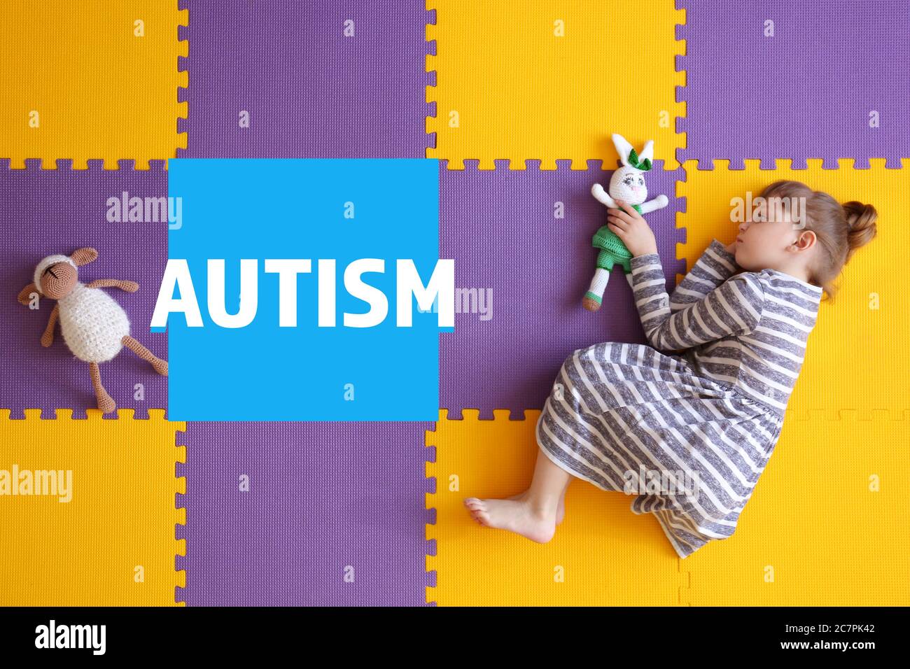 Little girl with autistic disorder lying on floor, top view Stock Photo ...