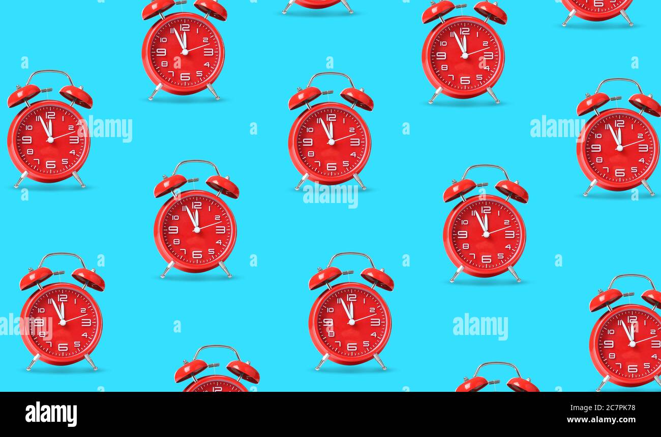 Many red alarm clocks on color background Stock Photo - Alamy