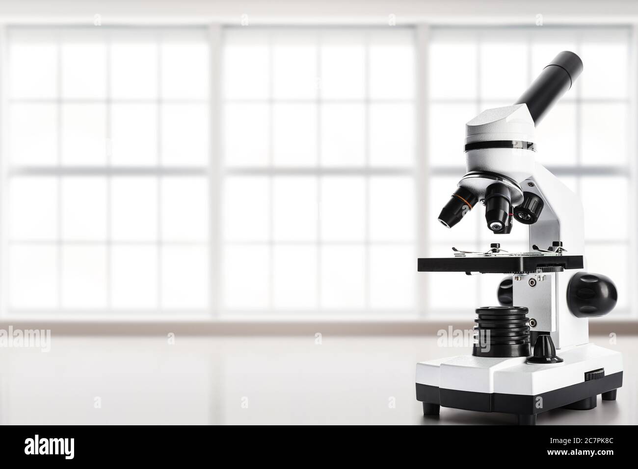 Modern microscope in empty room Stock Photo - Alamy