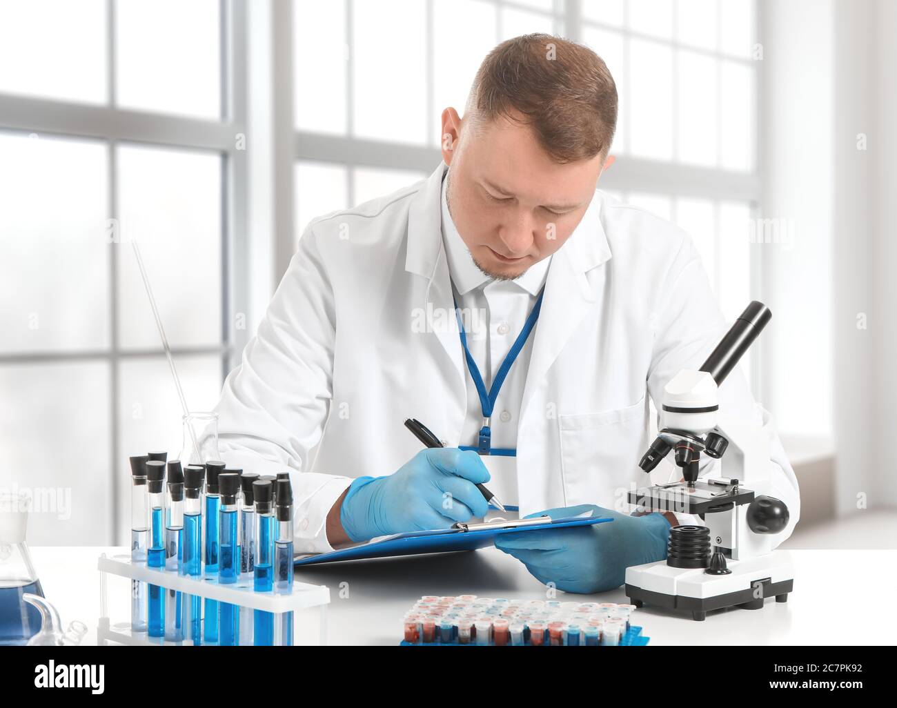 Scientist working with microscope in laboratory Stock Photo - Alamy