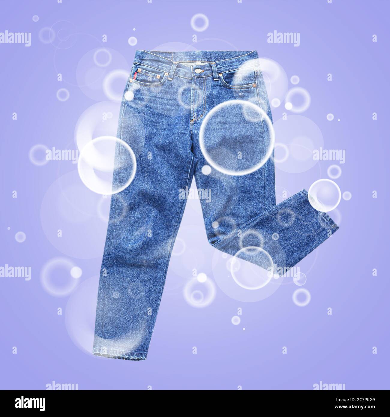 Clean pants with soap bubbles on color background Stock Photo - Alamy