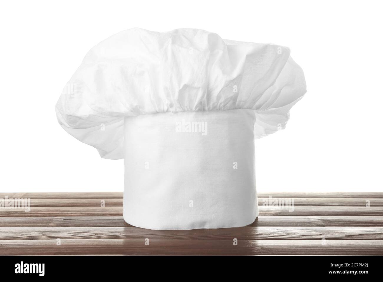 Chef's hat on table against white background Stock Photo - Alamy