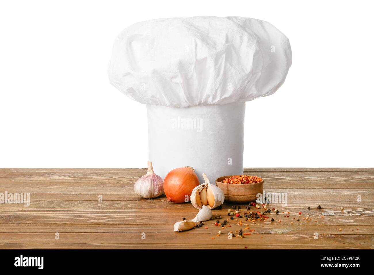 Chef's hat and spices on table against white background Stock Photo - Alamy