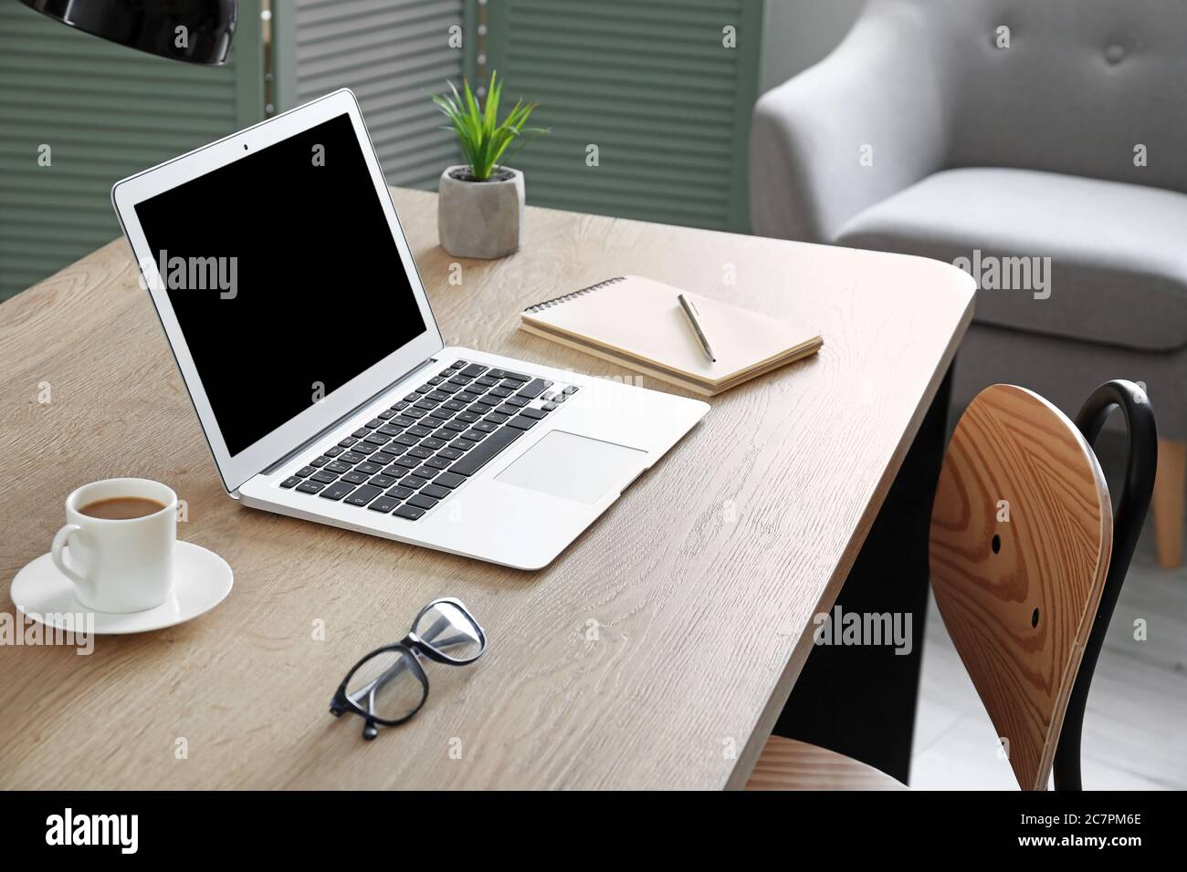 Modern workplace with laptop in room Stock Photo - Alamy