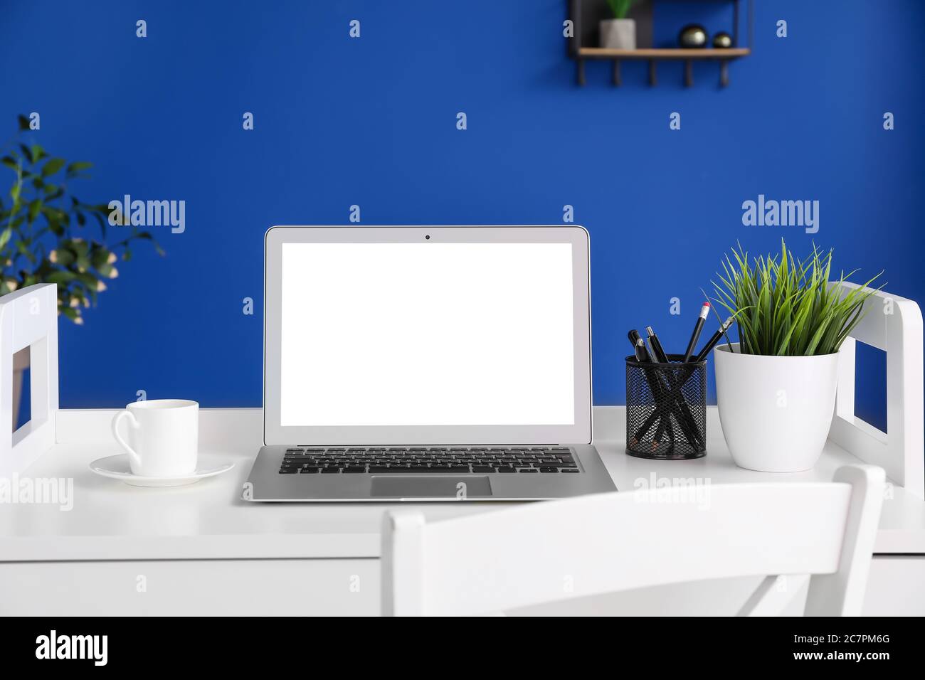 Modern workplace with laptop in room Stock Photo - Alamy