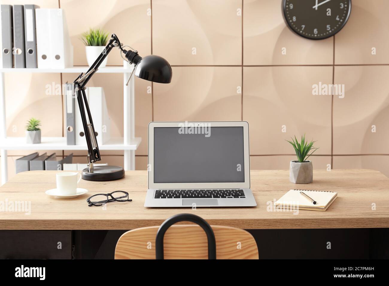 Modern workplace with laptop in room Stock Photo - Alamy
