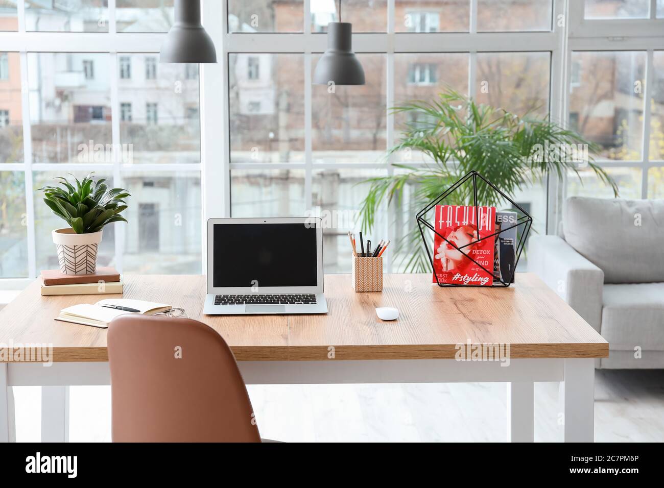 Modern workplace with laptop in room Stock Photo - Alamy