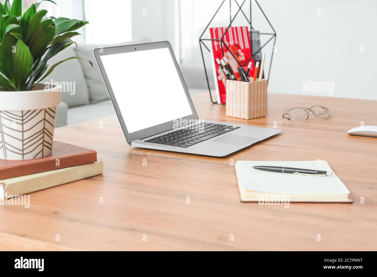Modern workplace with laptop in room Stock Photo - Alamy