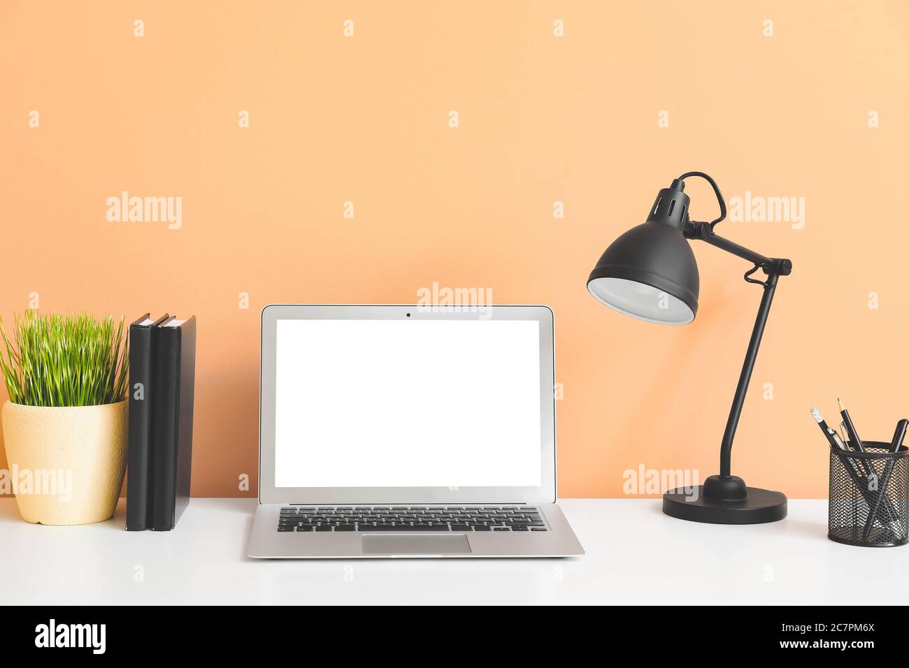 Modern workplace with laptop in room Stock Photo - Alamy