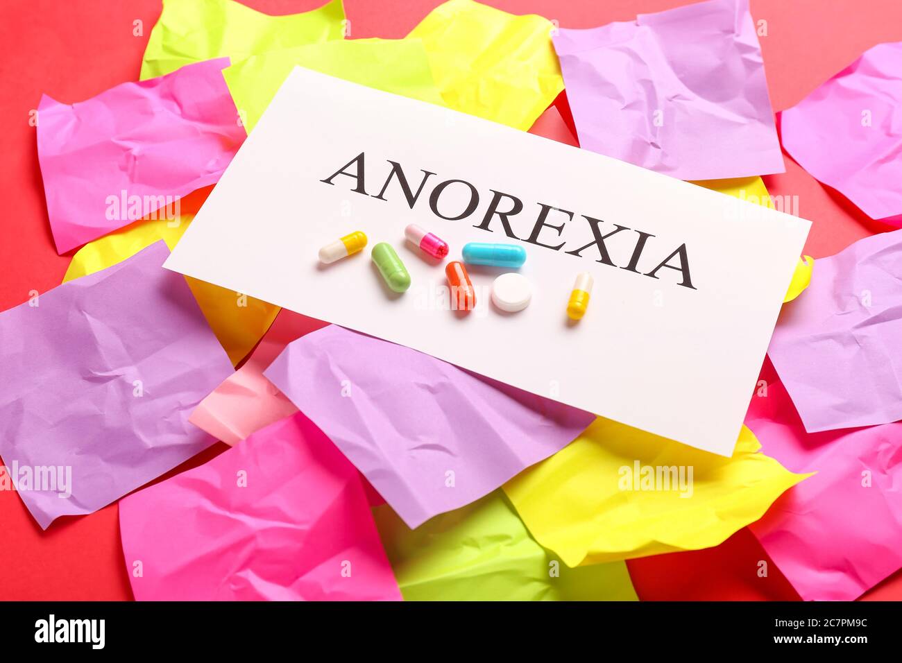 Word ANOREXIA with pills on color background Stock Photo - Alamy