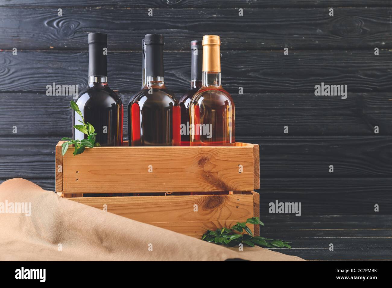 Box with bottles of wine on dark wooden background Stock Photo - Alamy