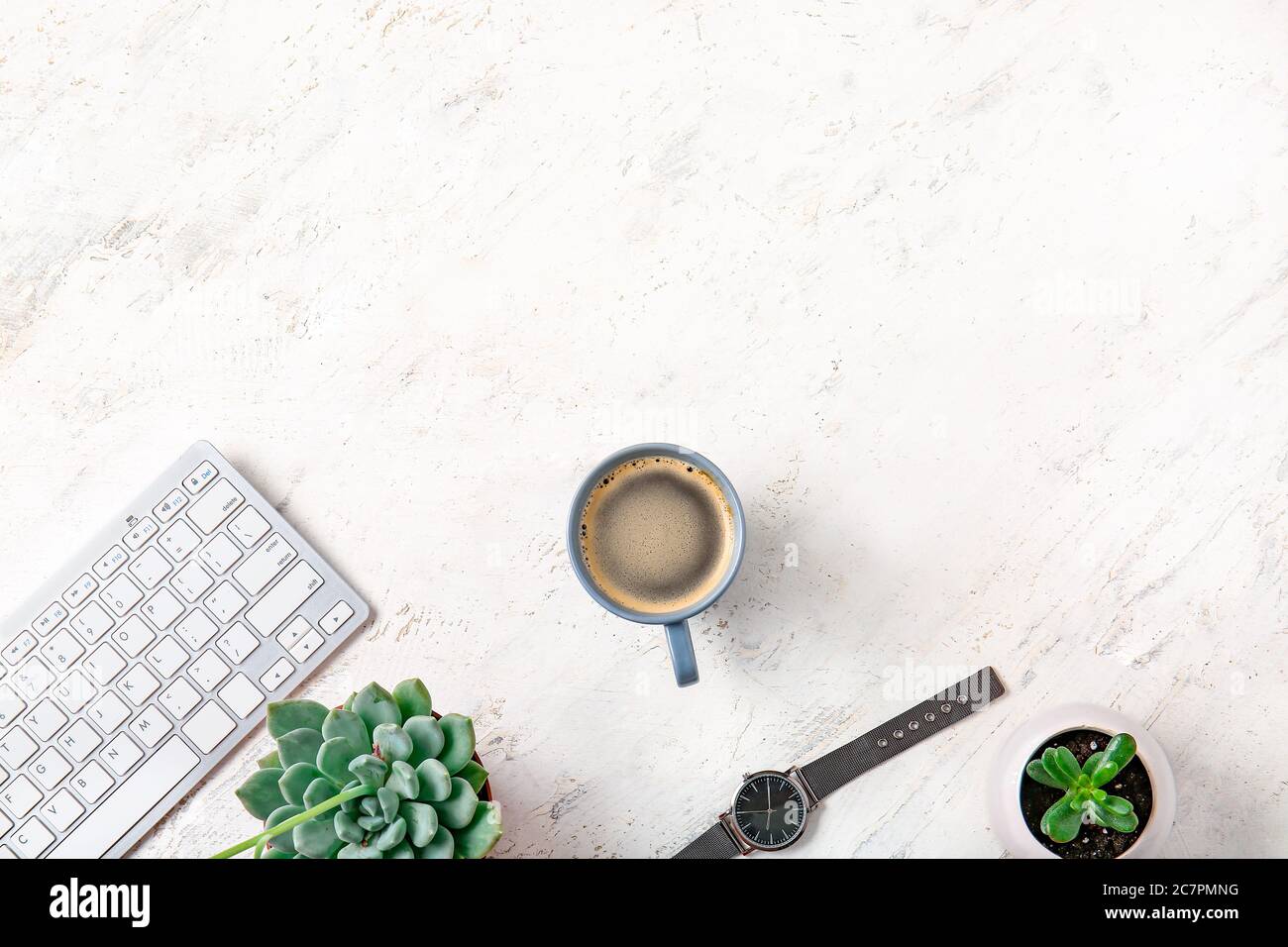 Cup of coffee with computer keyboard and clock on white background ...