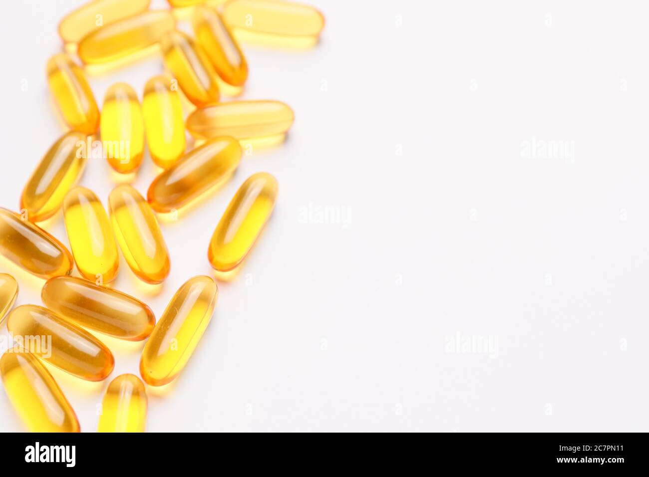 Fish oil capsules on white background Stock Photo - Alamy