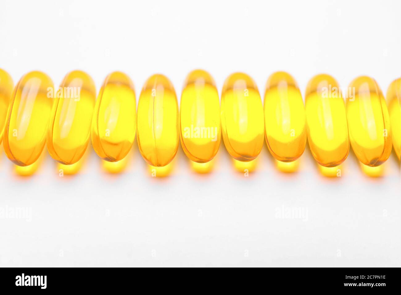 Fish oil capsules on white background Stock Photo - Alamy
