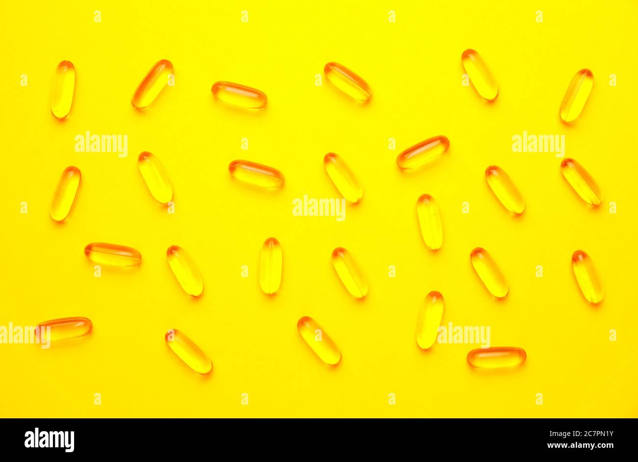 Fish oil capsules on color background Stock Photo - Alamy