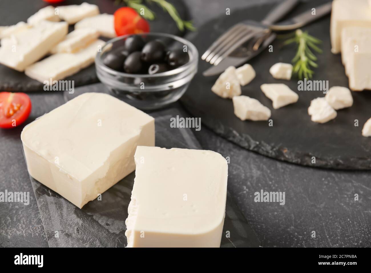 Tasty feta cheese on dark background Stock Photo - Alamy
