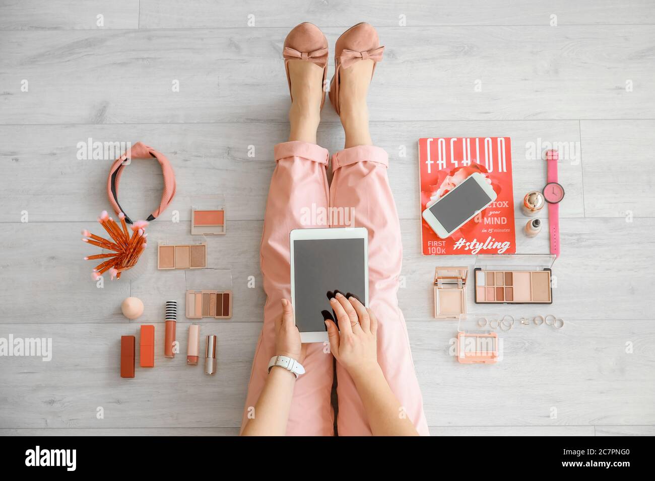 Makeup artist with modern tablet computer, mobile phone and decorative ...