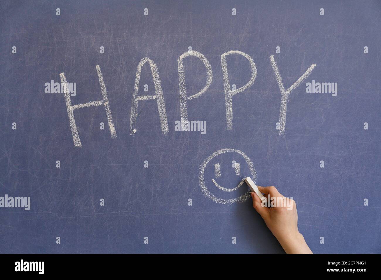 Word HAPPY and female hand drawing smile on dark background Stock Photo ...