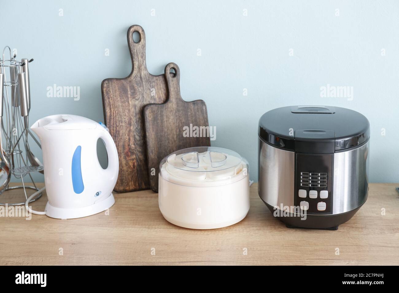 Different household appliances on table in kitchen Stock Photo - Alamy