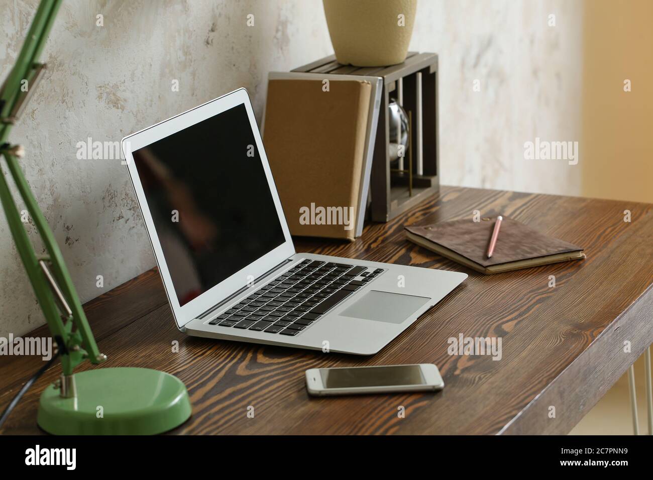 Modern laptop and mobile phone at workplace in room Stock Photo - Alamy