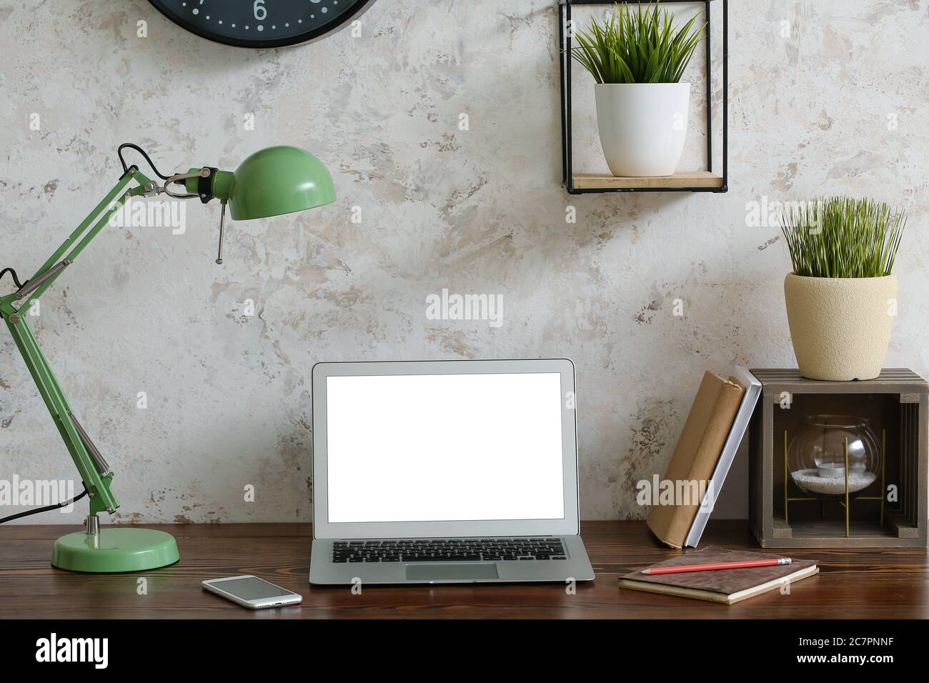 Modern laptop and mobile phone at workplace in room Stock Photo - Alamy