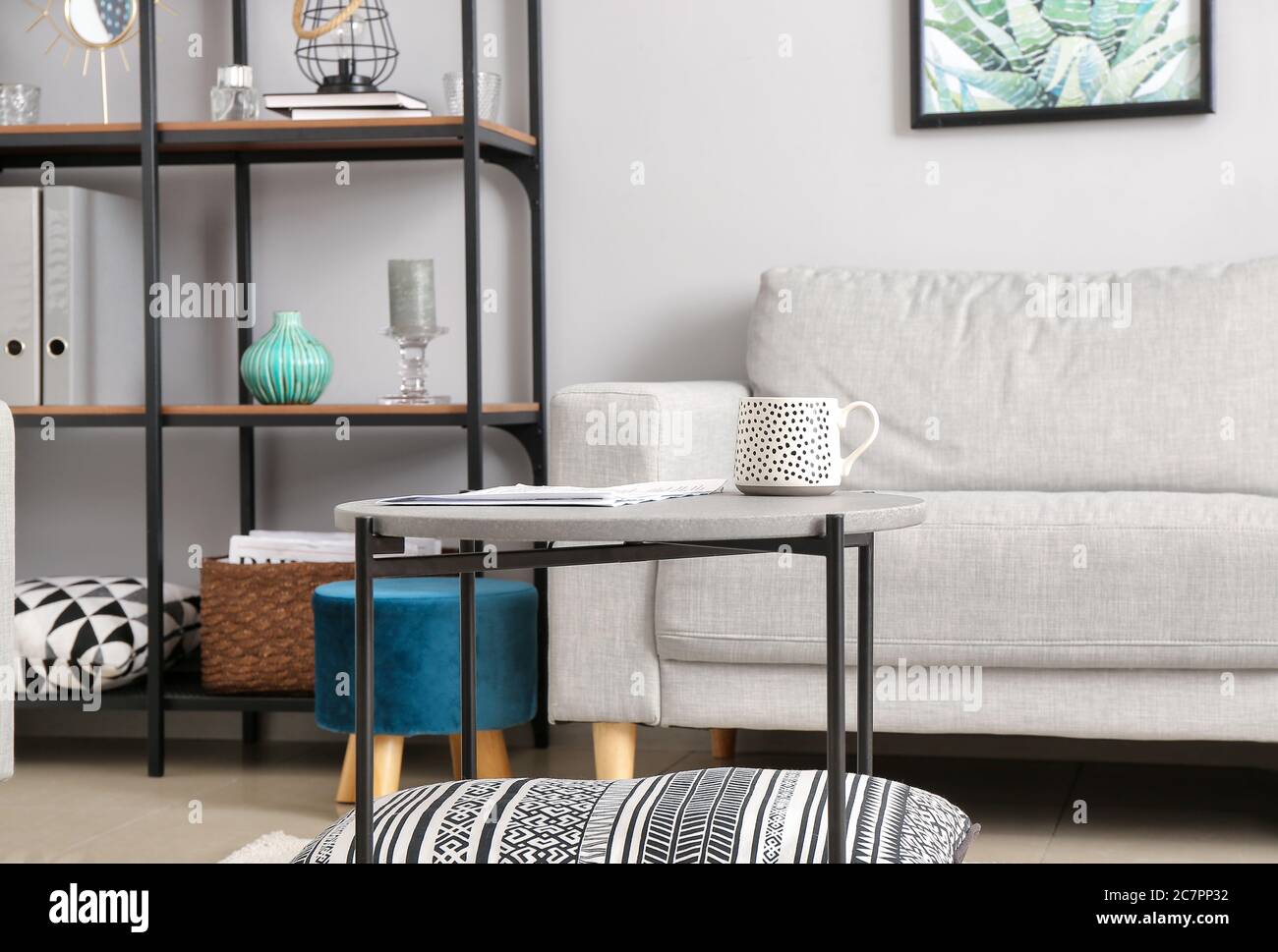 Stylish sofa, table and rack in interior of living in room Stock Photo ...