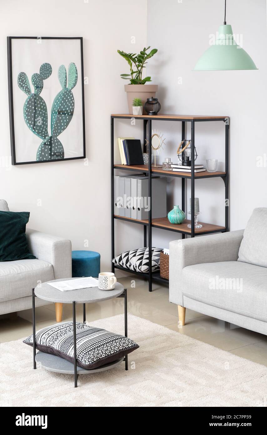 Stylish sofas, table and rack in interior of living in room Stock Photo ...