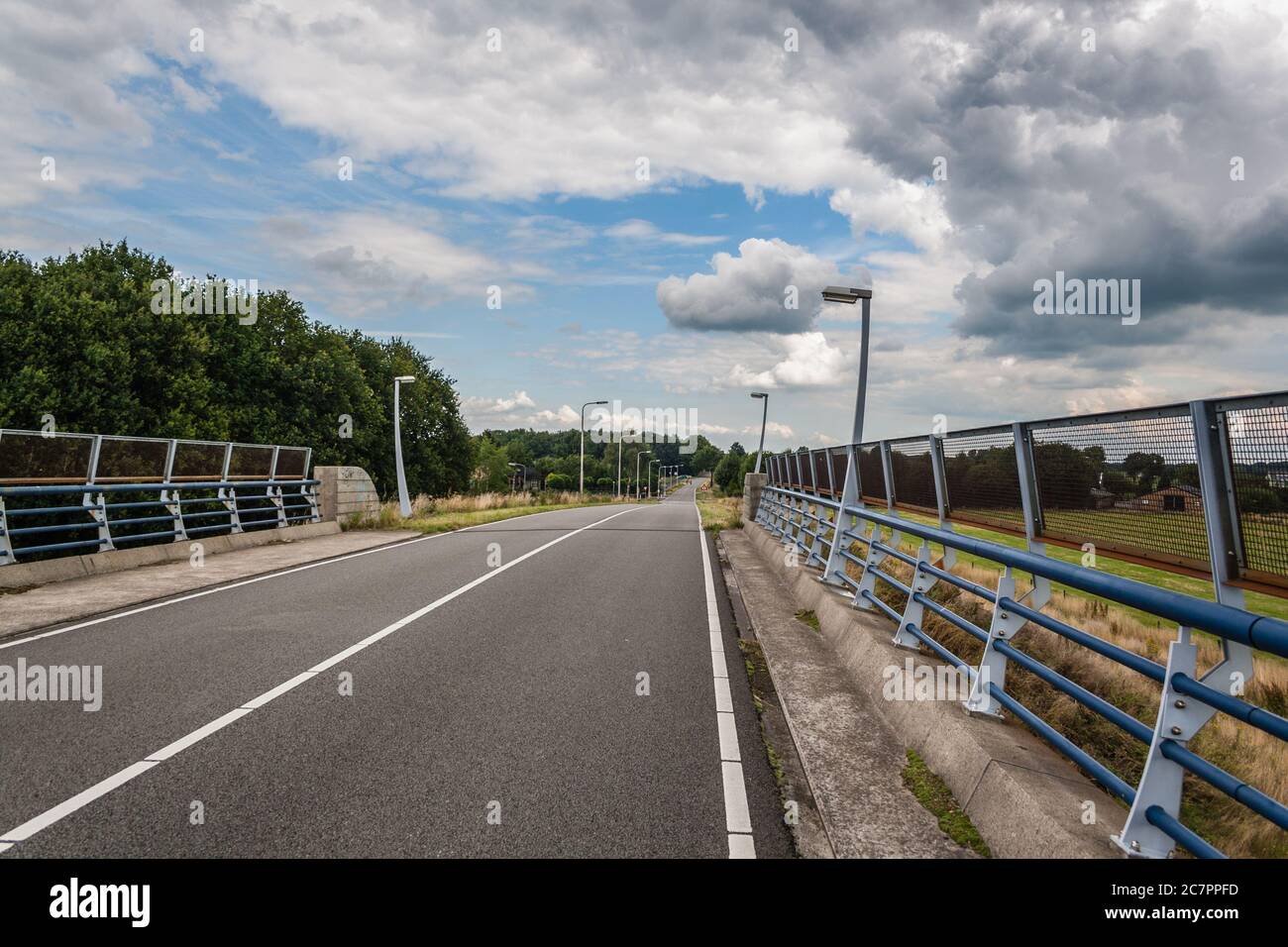 small bridge with lampposts crossing over a freeway in a rural ...