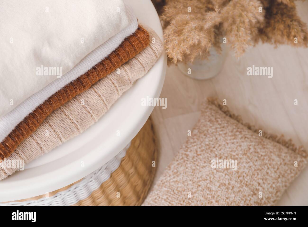 Stack of clean clothes on table in room Stock Photo - Alamy