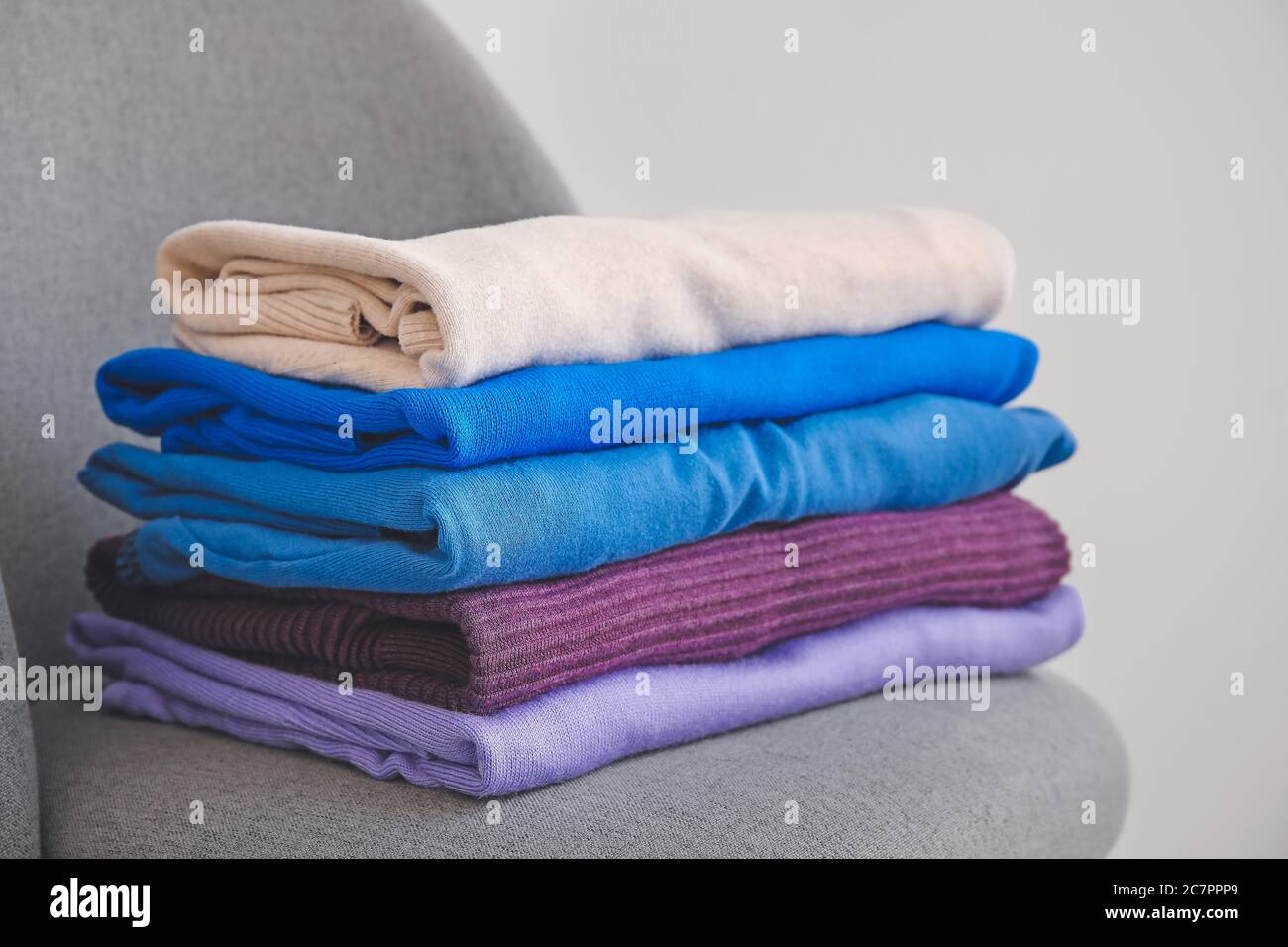 Stack of clean clothes on chair, closeup Stock Photo - Alamy